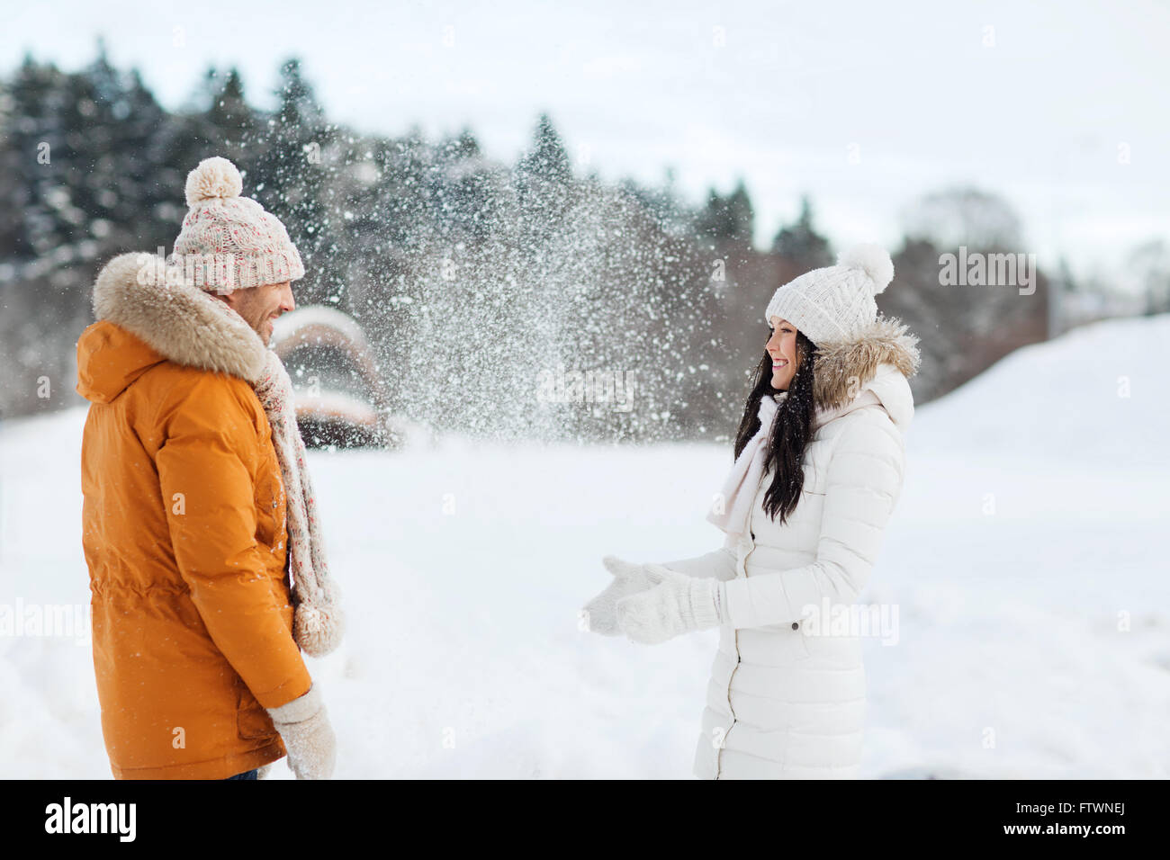 happy couple playing with snow in winter Stock Photo - Alamy