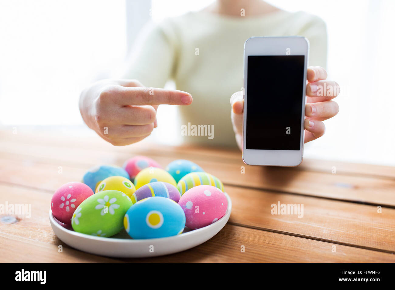 close up of hands with easter eggs and smartphone Stock Photo - Alamy