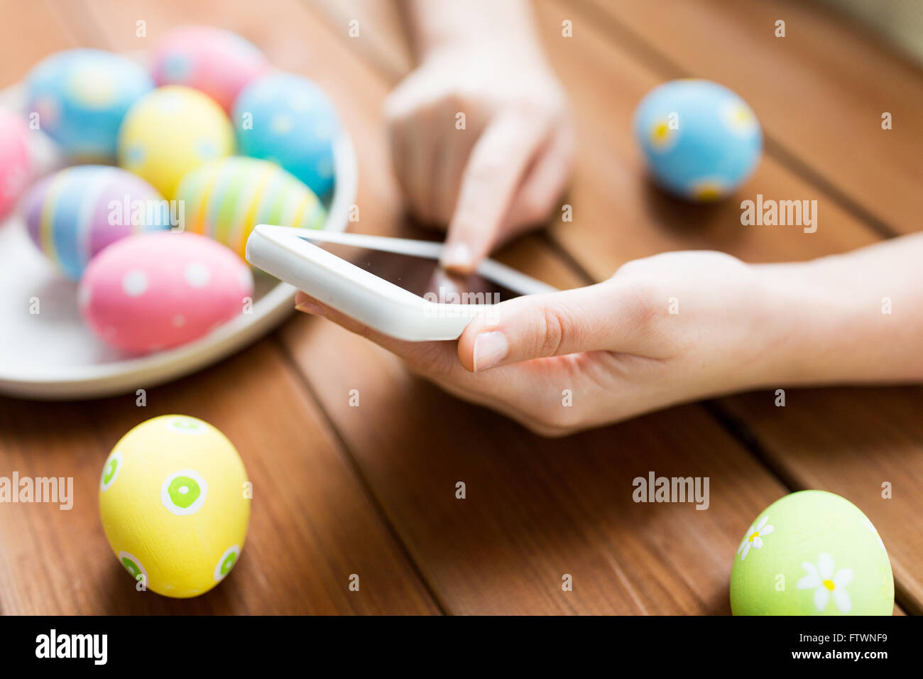 close up of hands with easter eggs and smartphone Stock Photo - Alamy