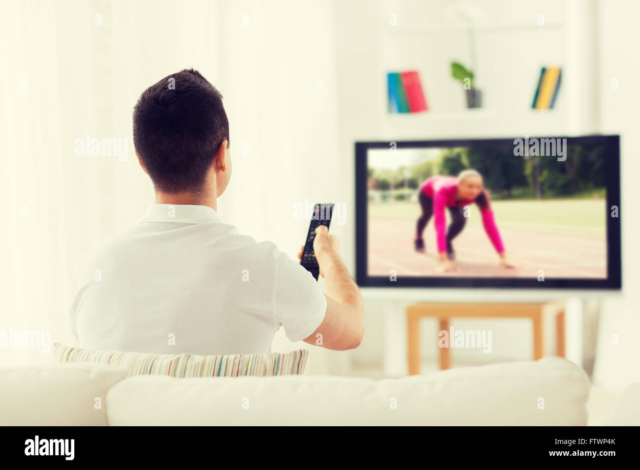 man watching sport channel on tv at home Stock Photo - Alamy