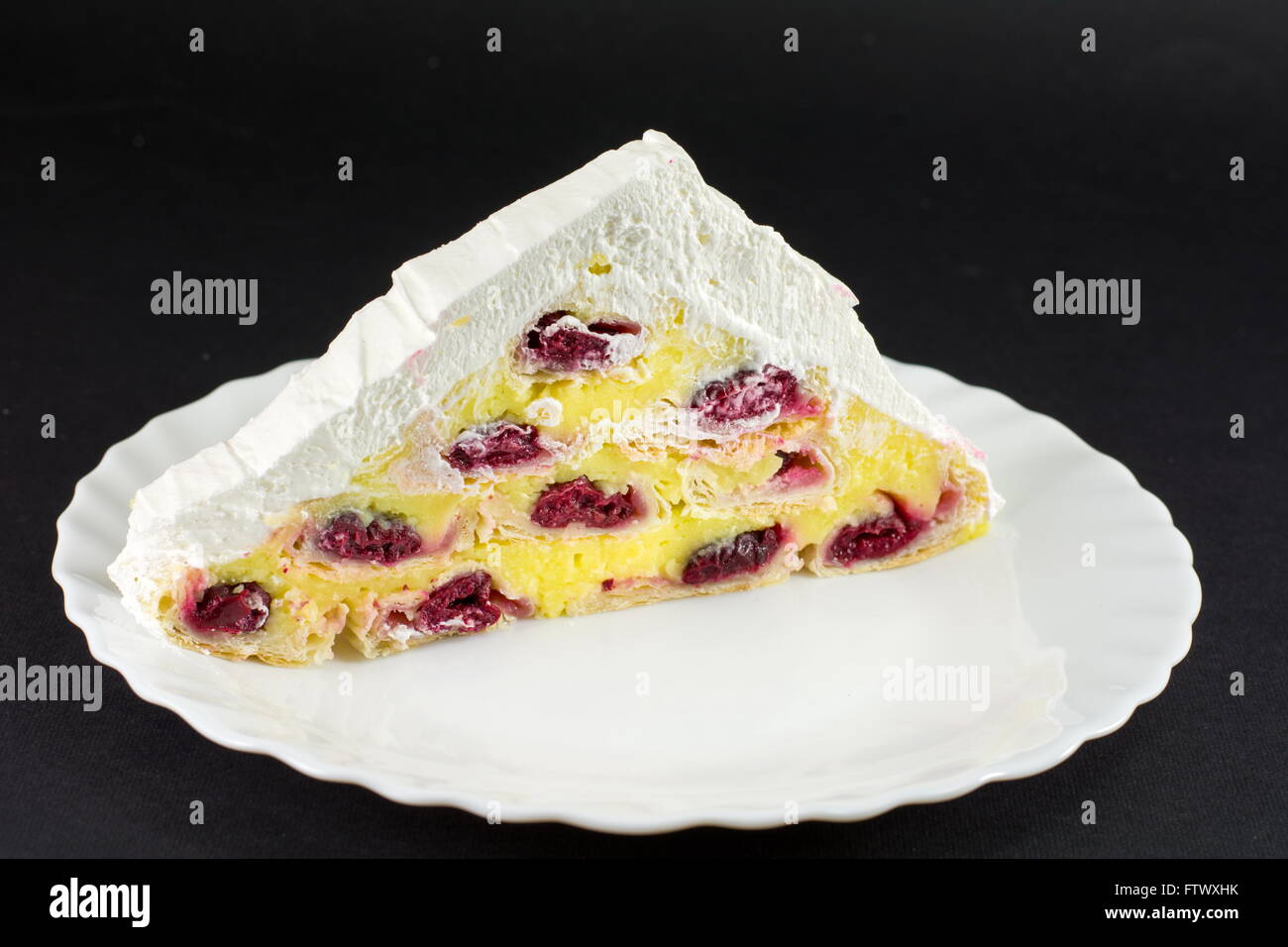 triangle cherry cake on black background Stock Photo - Alamy