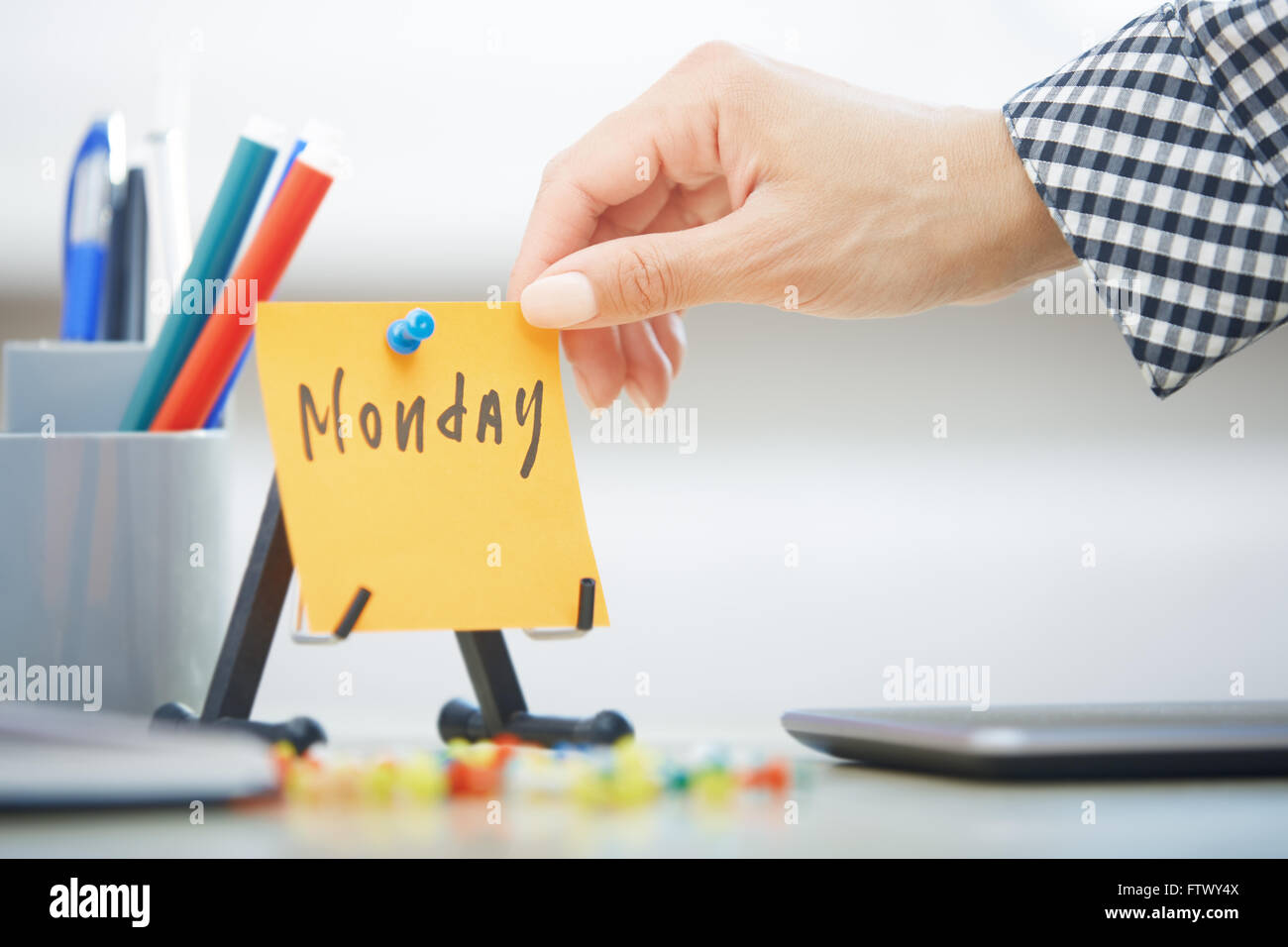 Human hand holding adhesive note with Monday text Stock Photo - Alamy