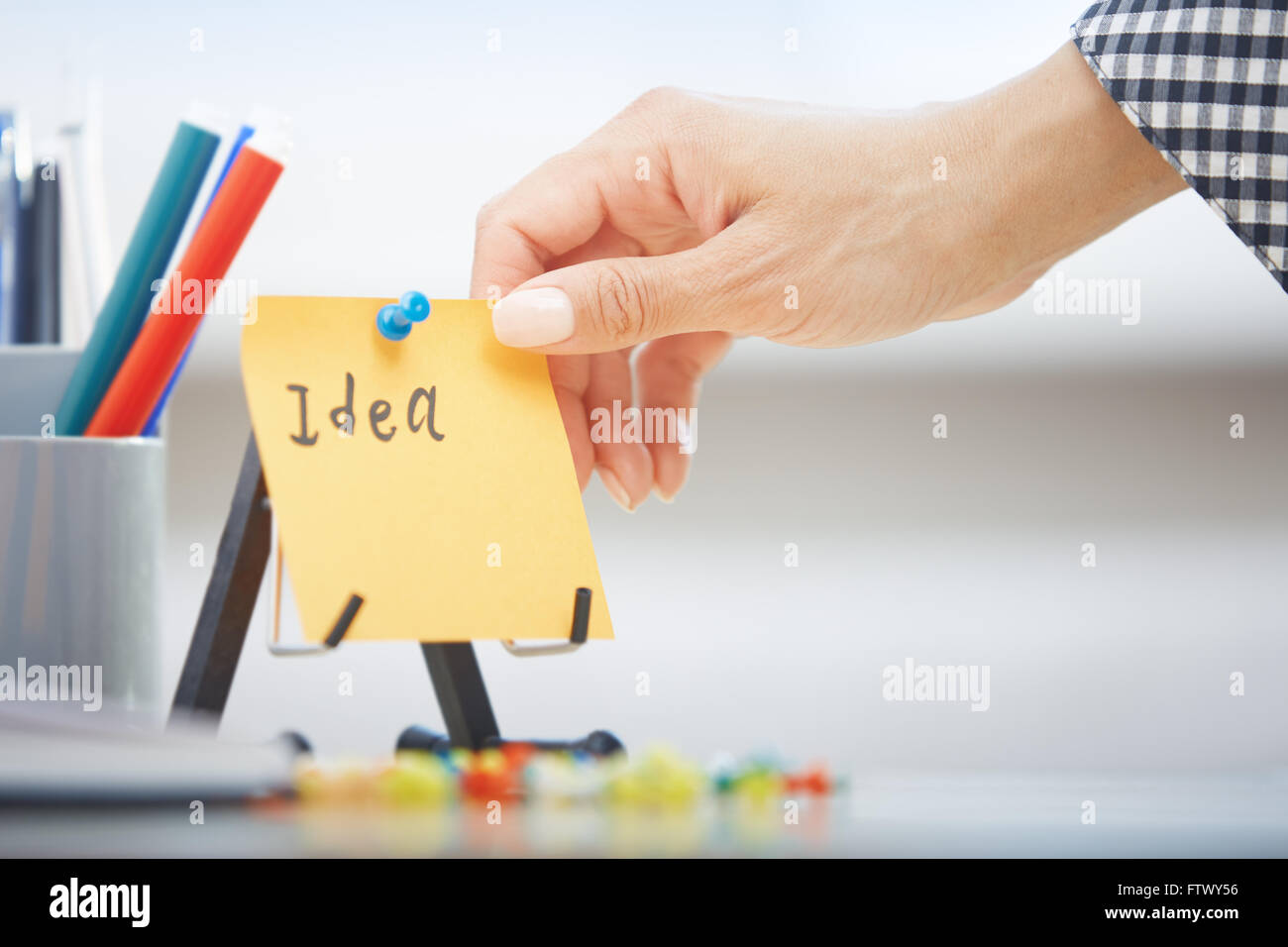 Human hand holding adhesive note with Idea text Stock Photo - Alamy