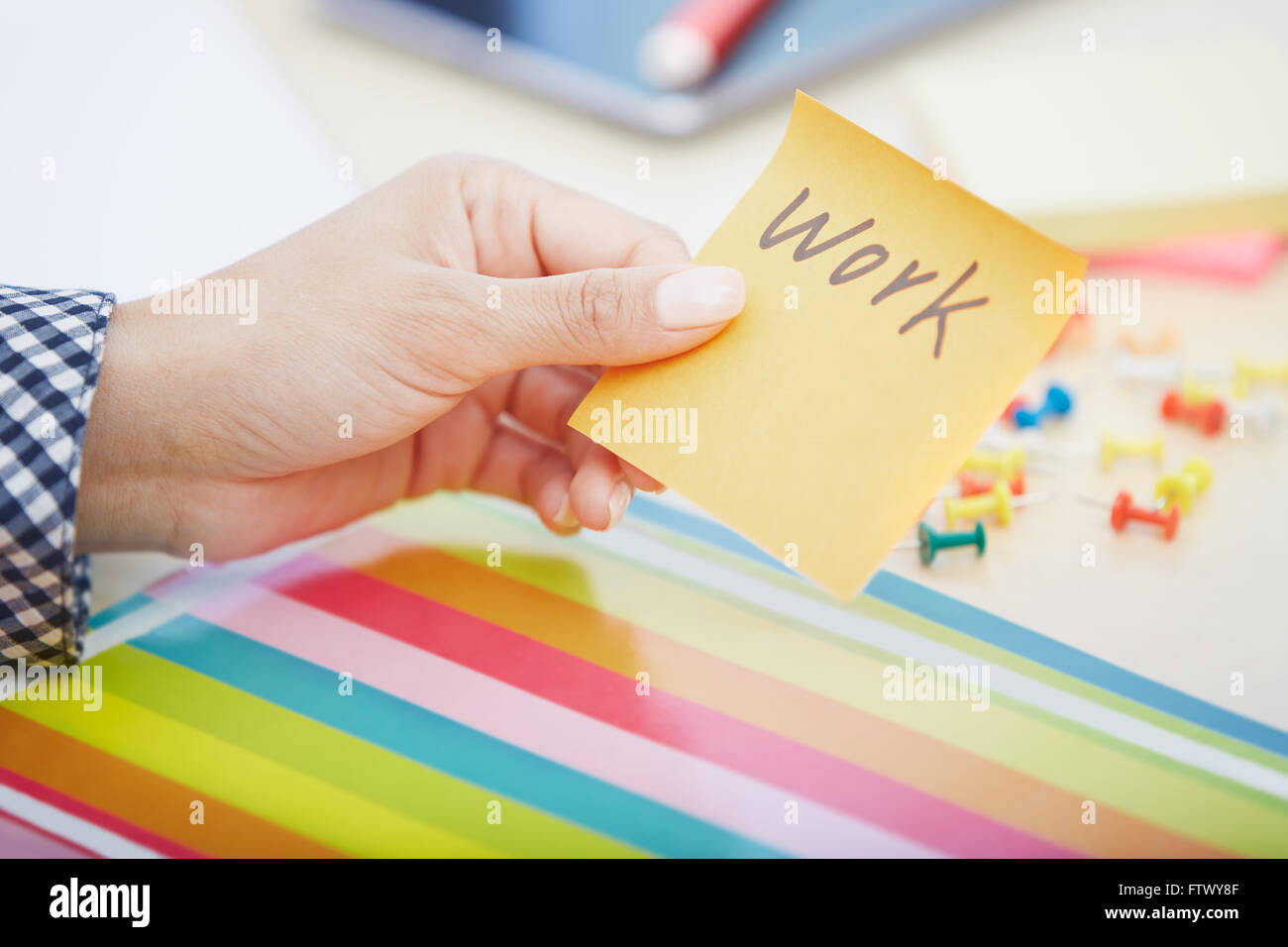 Human hand holding adhesive note with Work text Stock Photo - Alamy