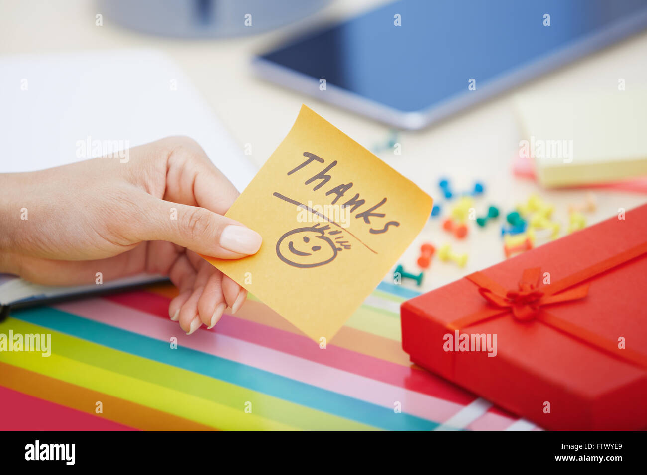 Human hand holding adhesive note with Thanks text Stock Photo - Alamy