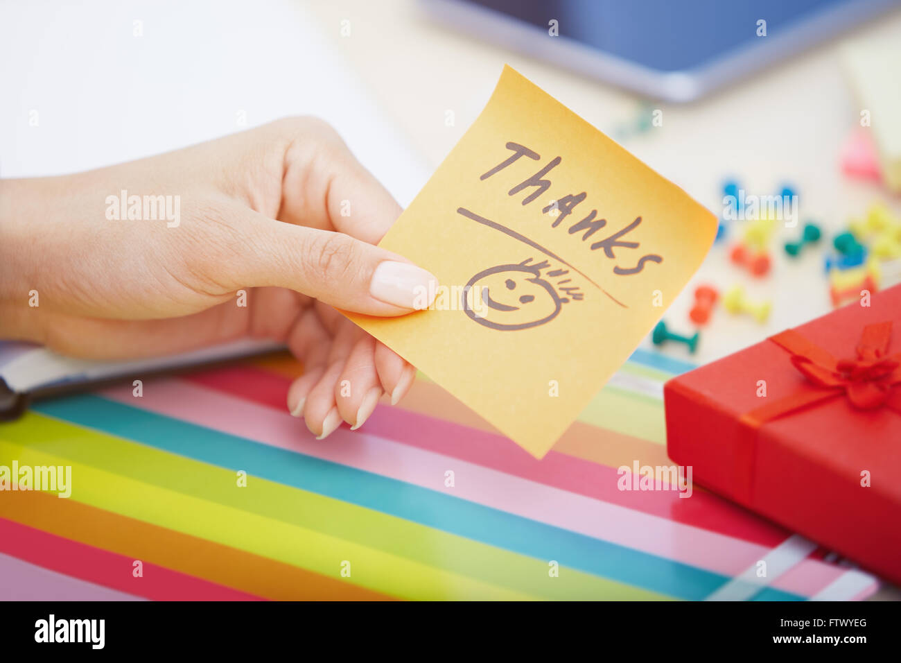 Human hand holding adhesive note with Thanks text Stock Photo - Alamy