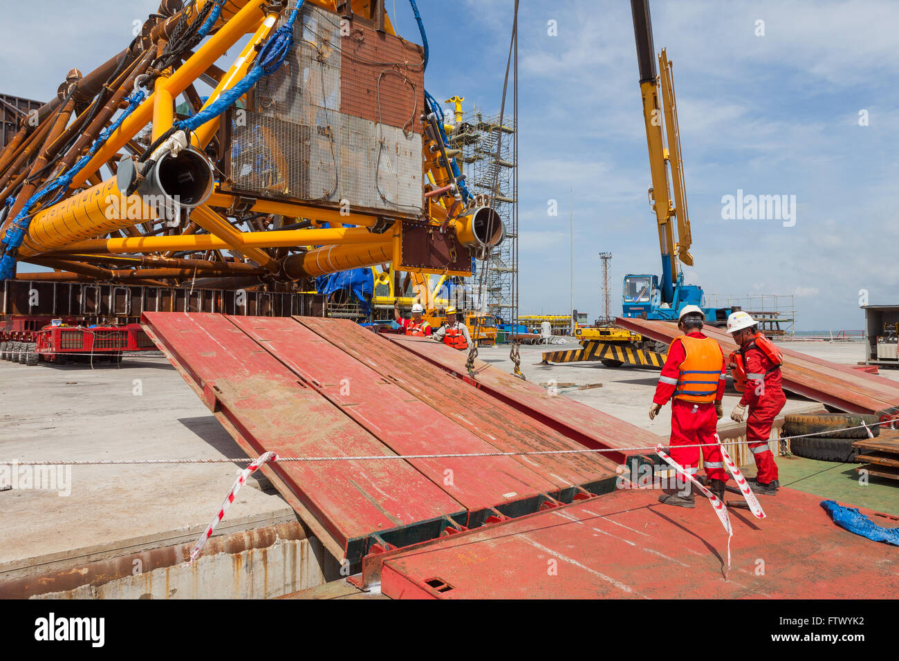 Men working in front of a rig jacket before transfer to a barge Stock ...
