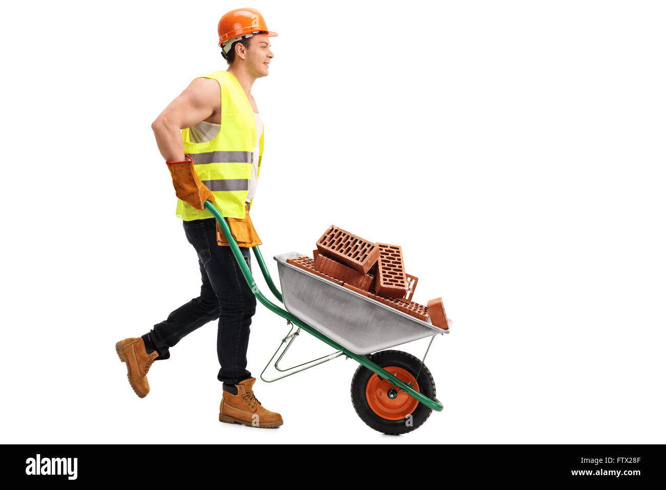 Construction worker pushing a wheelbarrow full of bricks isolated on ...