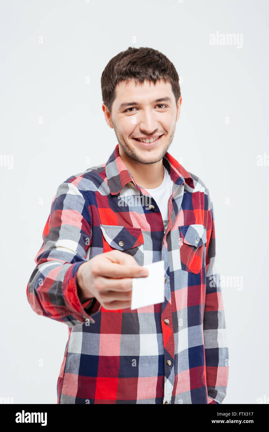 Happy casual man giving blank card isolated on a white background Stock ...