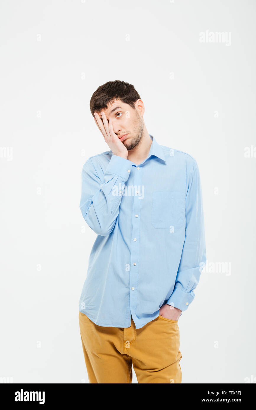Stressed man standing isolated on a white background Stock Photo - Alamy