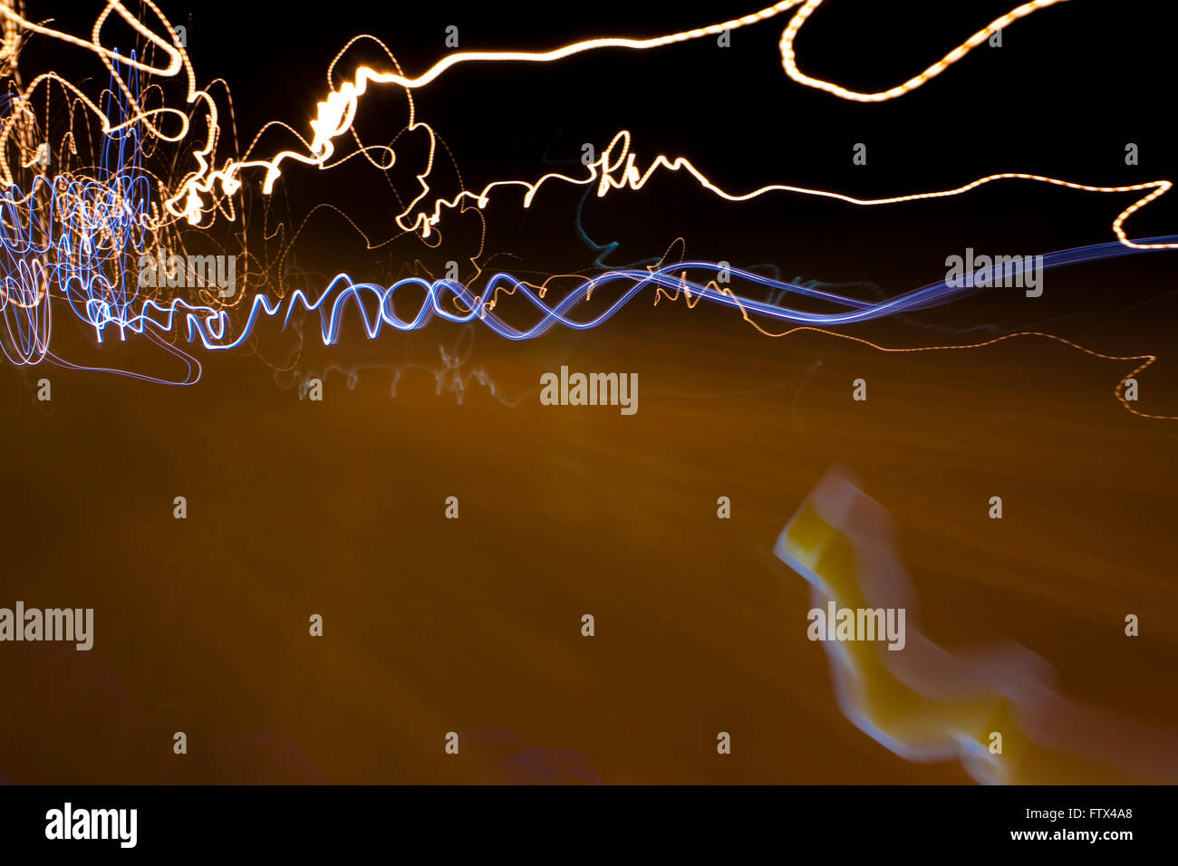 Abstract light patterns that imply movement or travel along roads and ...