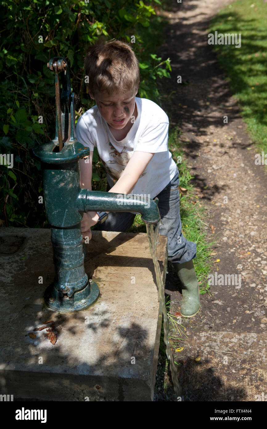 Boy pumping well water hi-res stock photography and images - Alamy