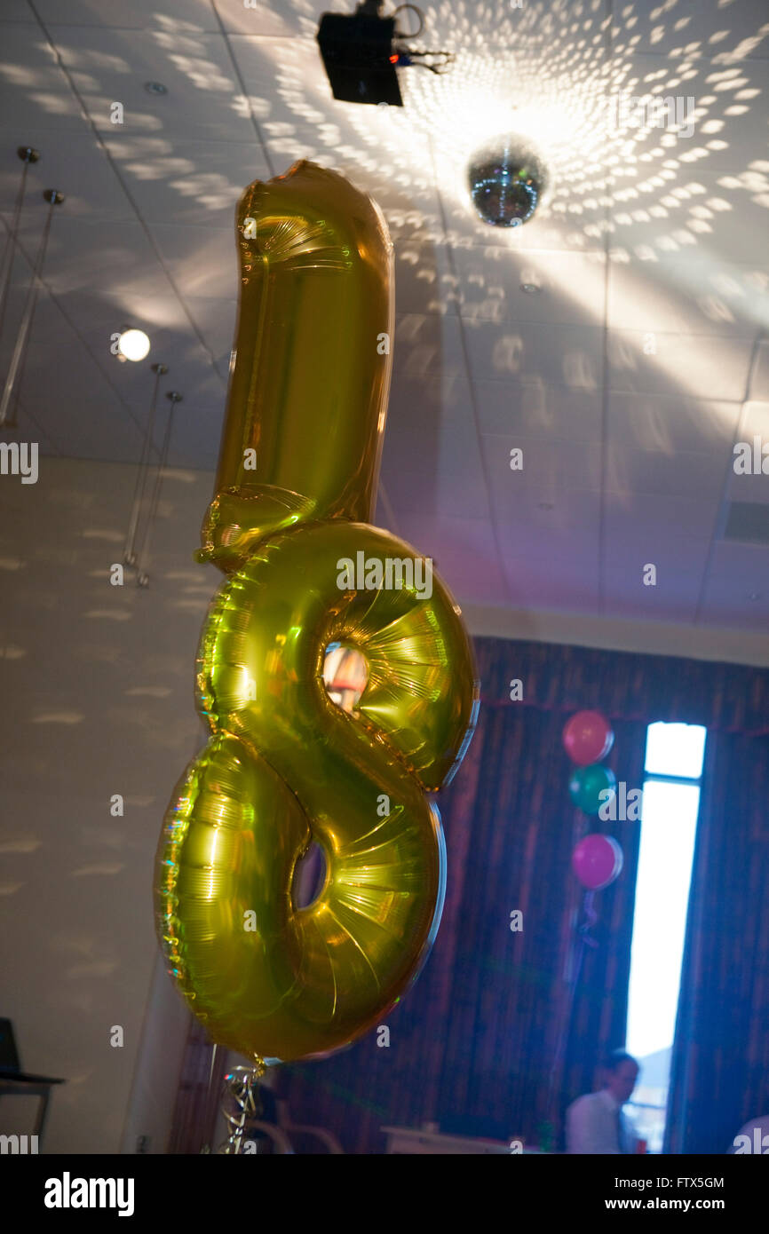 Helium ballons in the shape of the numbers one and eight floating ...