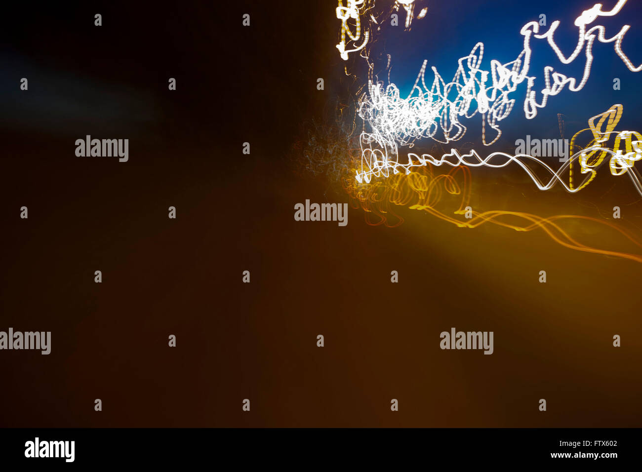Abstract light patterns that imply movement or travel along roads and ...