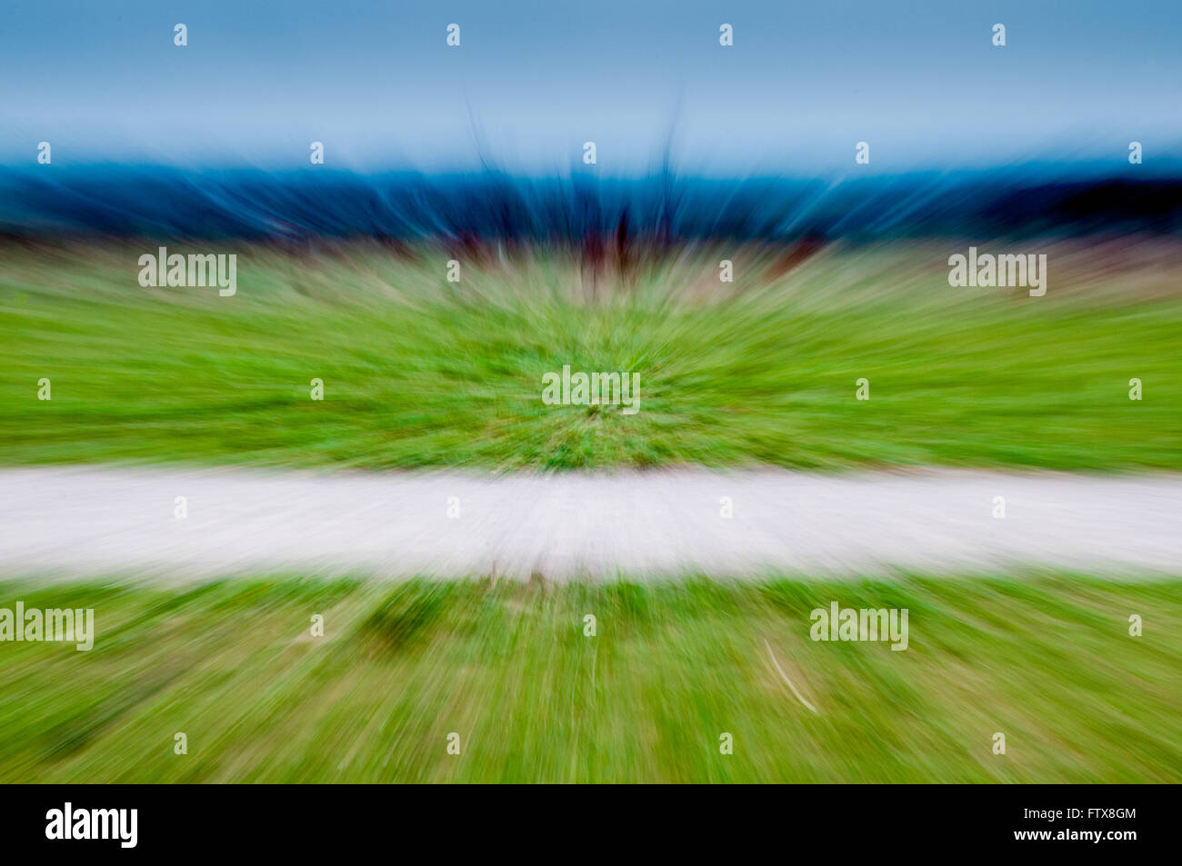 motion blur from a countryside pathway with grass and sky Stock Photo ...