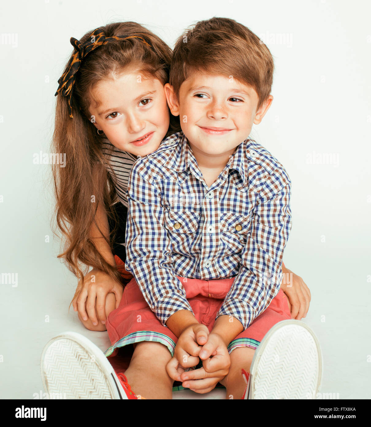 little cute boy and girl hugging playing on white background, happy family Stock Photo - Alamy