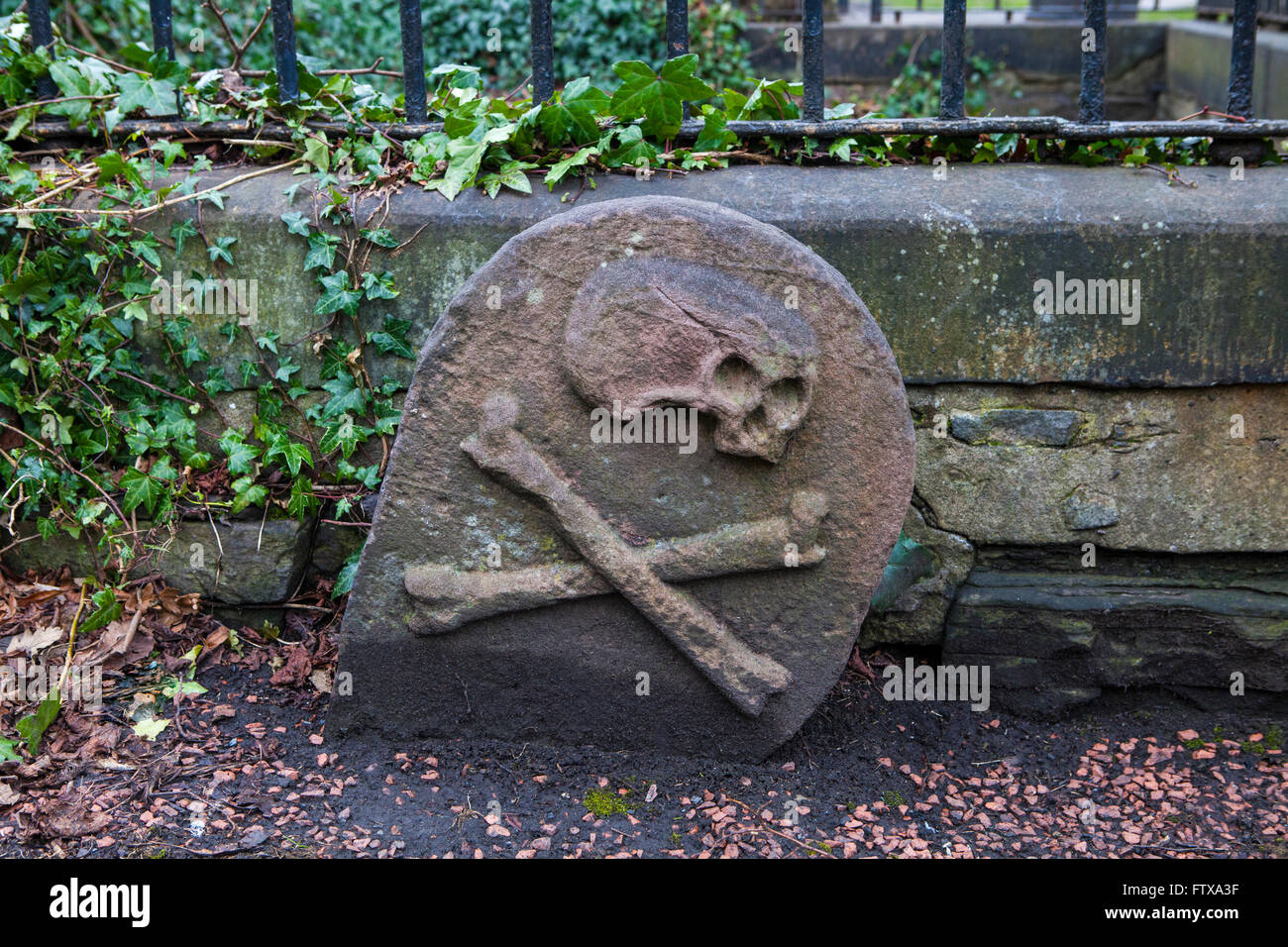 A close-up of a Skull and Crossbones on a headstone in a graveyard ...