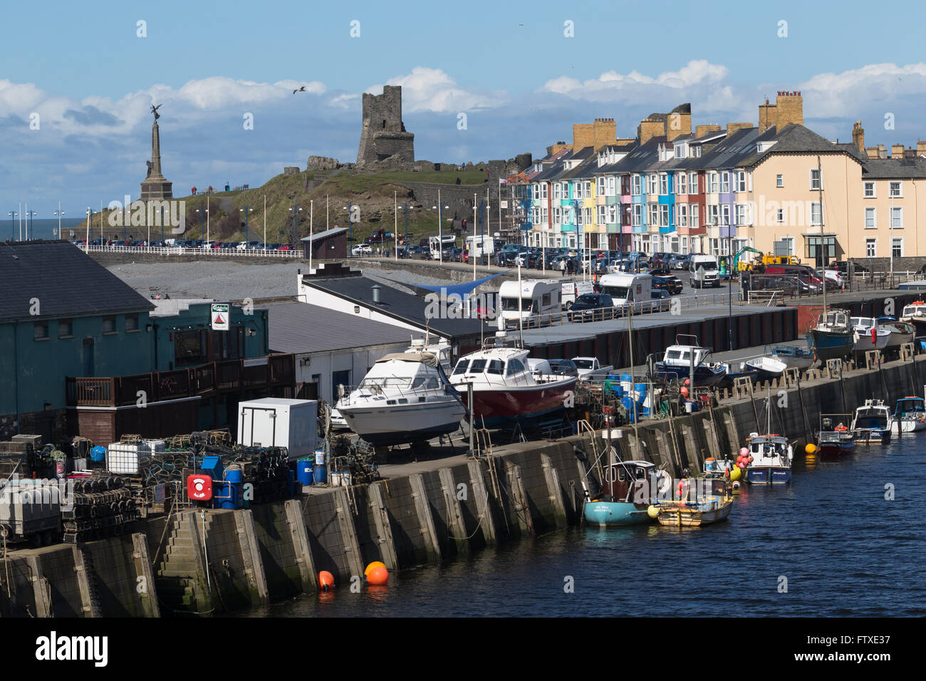Aberystwyth harbour, South Marine Terrace, castle and war memorial on a ...