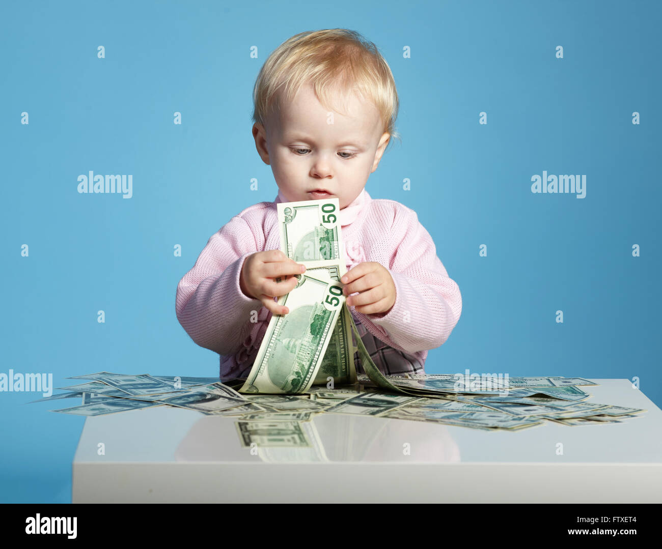 little child with dollars on table Stock Photo - Alamy