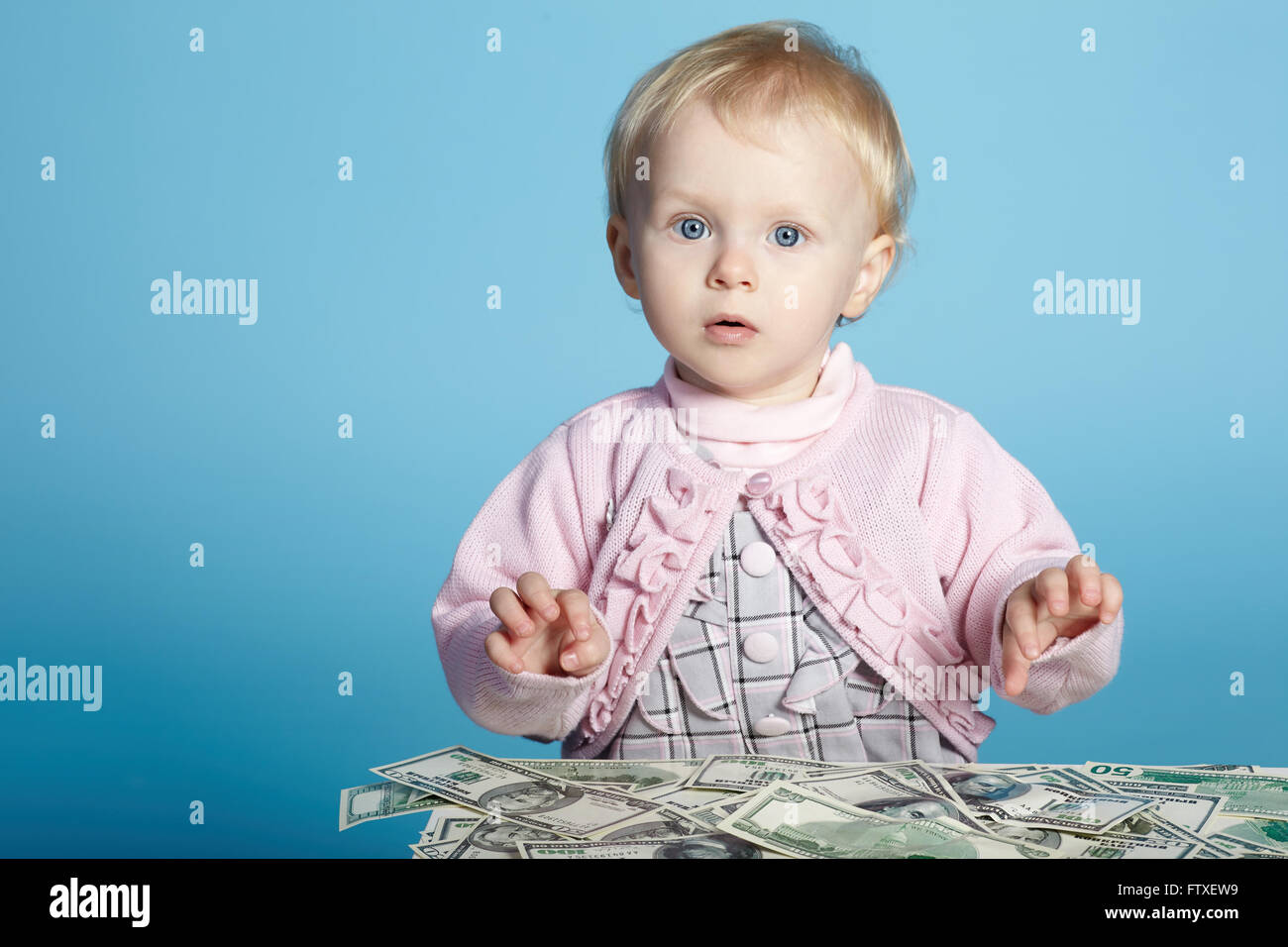 little child with dollars on table Stock Photo - Alamy