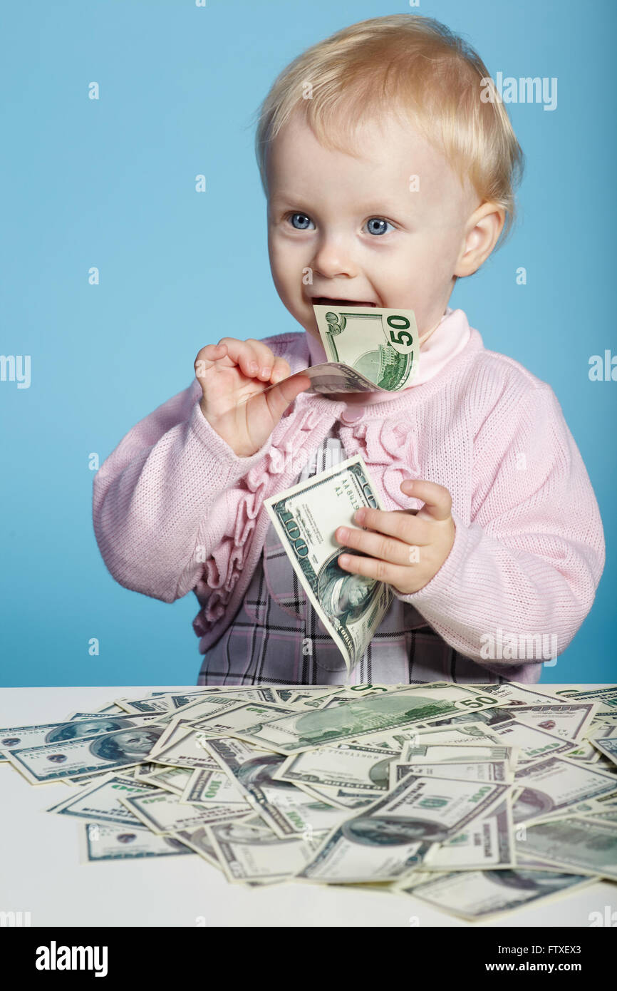little child with dollars on table Stock Photo - Alamy