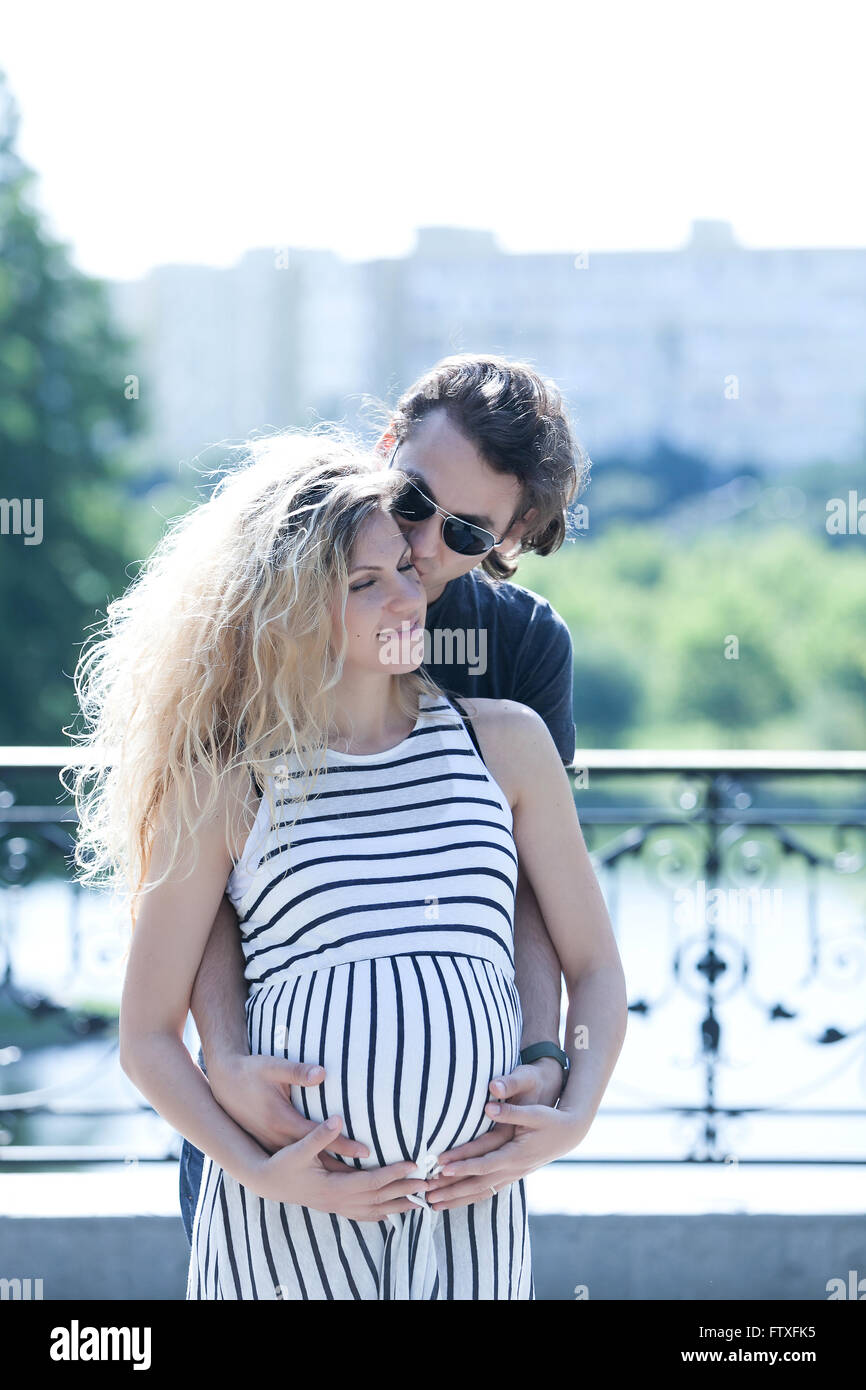 Young couple preparing for the baby arrival, relaxing and having fun in ...