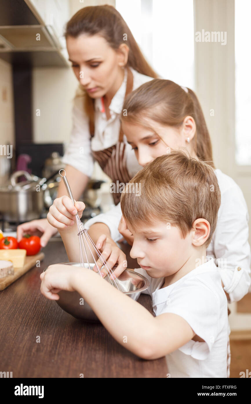 Family cooking background. Mum and children in the kitchen. Small boy ...