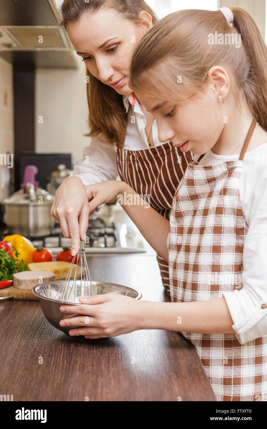 Family cooking background. Mum and daughter whisking eggs at the ...