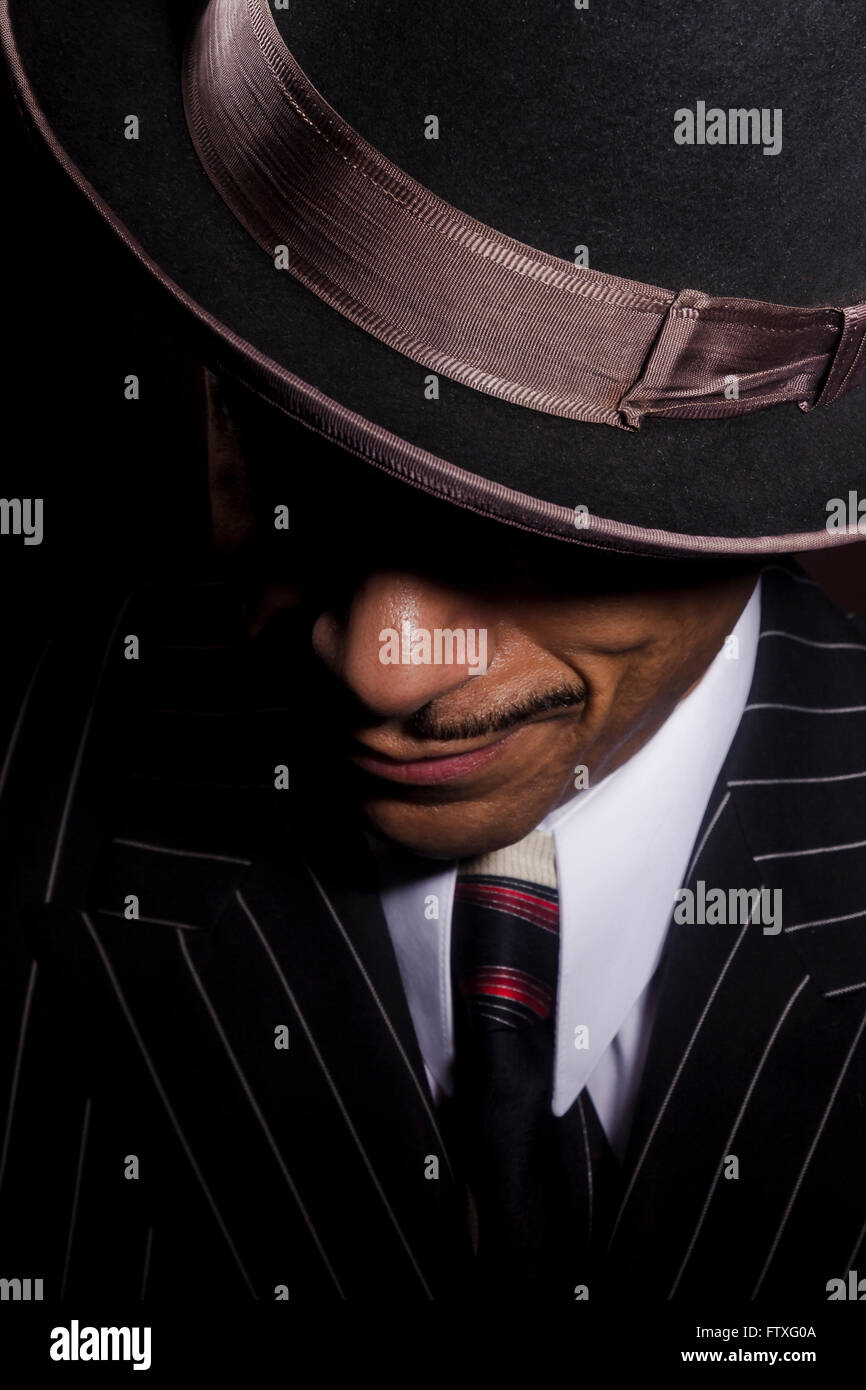 Studio portrait of a smiling gangster Stock Photo - Alamy