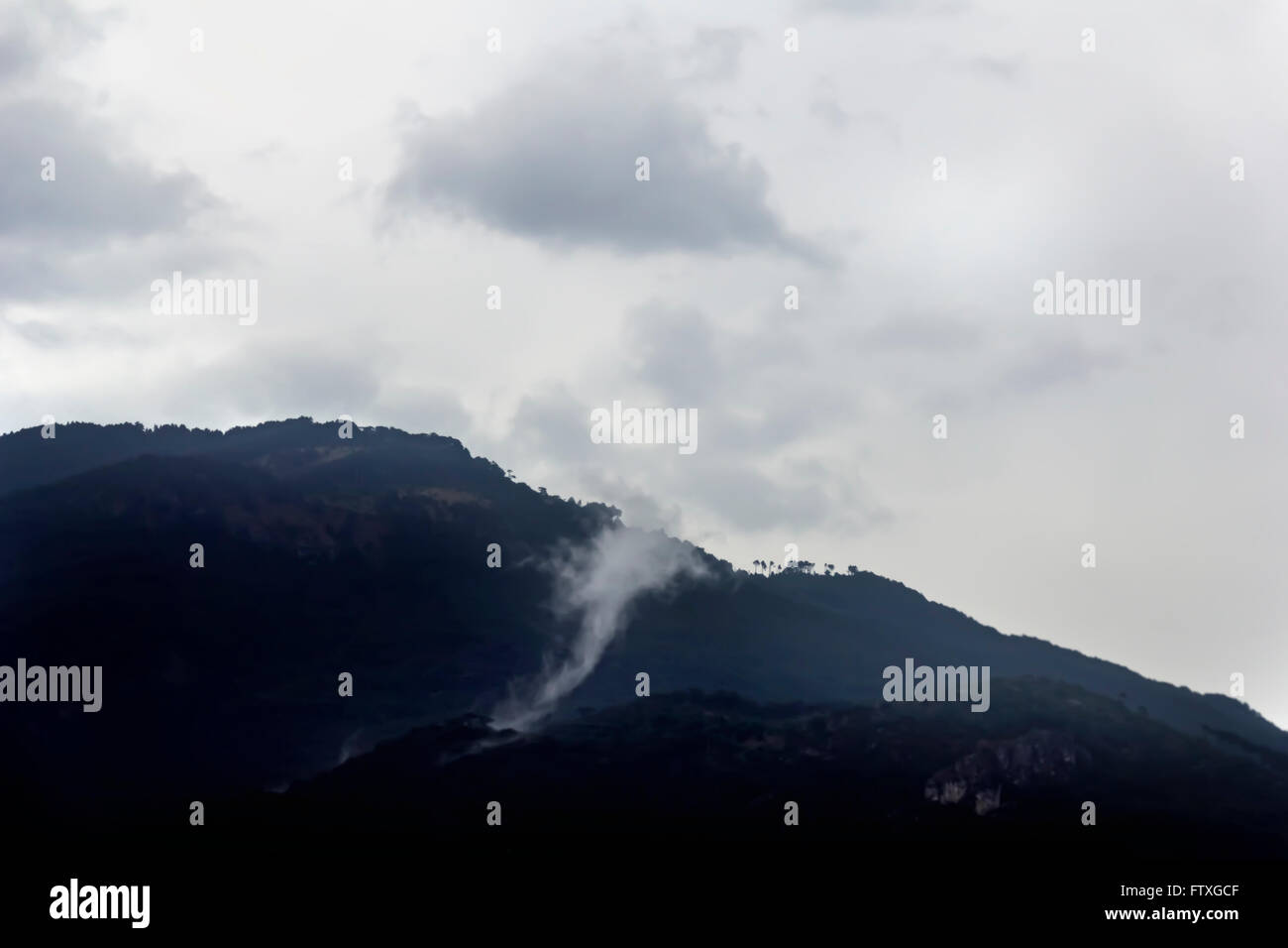 White clouds over mountain on cloudy morning Stock Photo - Alamy