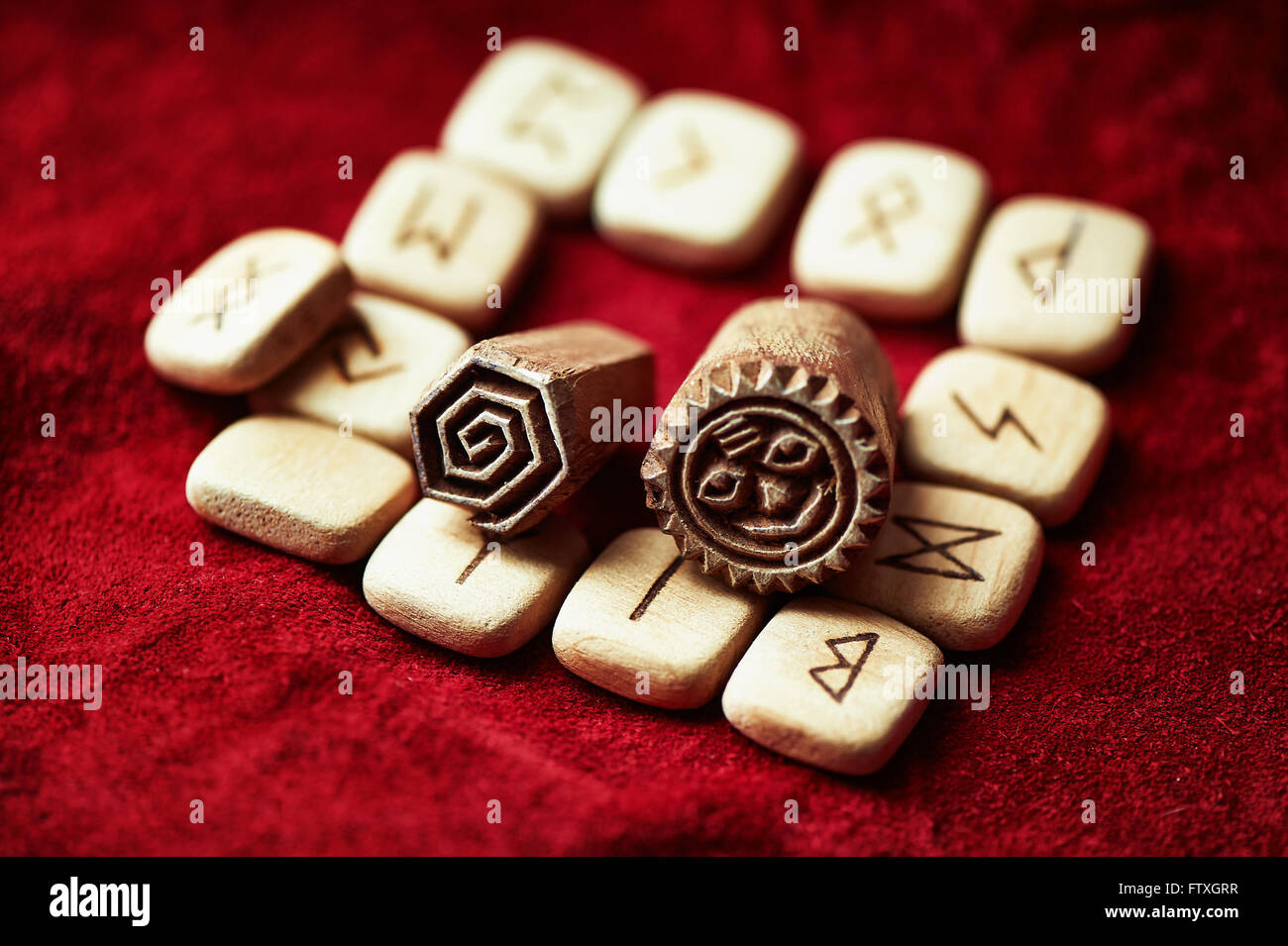 Rune on a background of red rough suede mint Stock Photo - Alamy