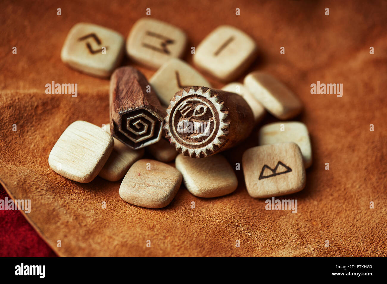 Rune on a background of brown rough suede mint Stock Photo - Alamy