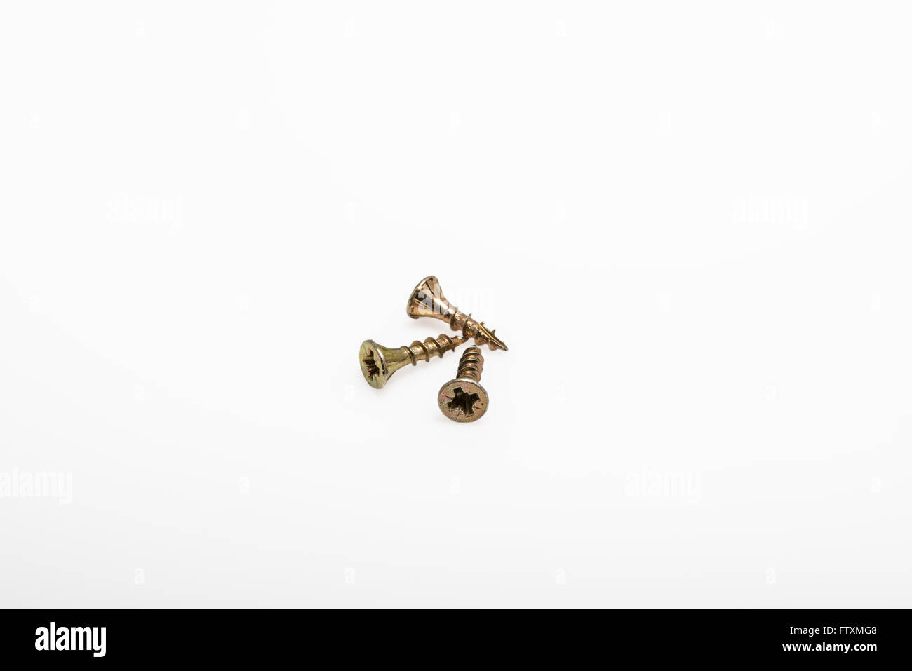 Three screws on white background Stock Photo - Alamy