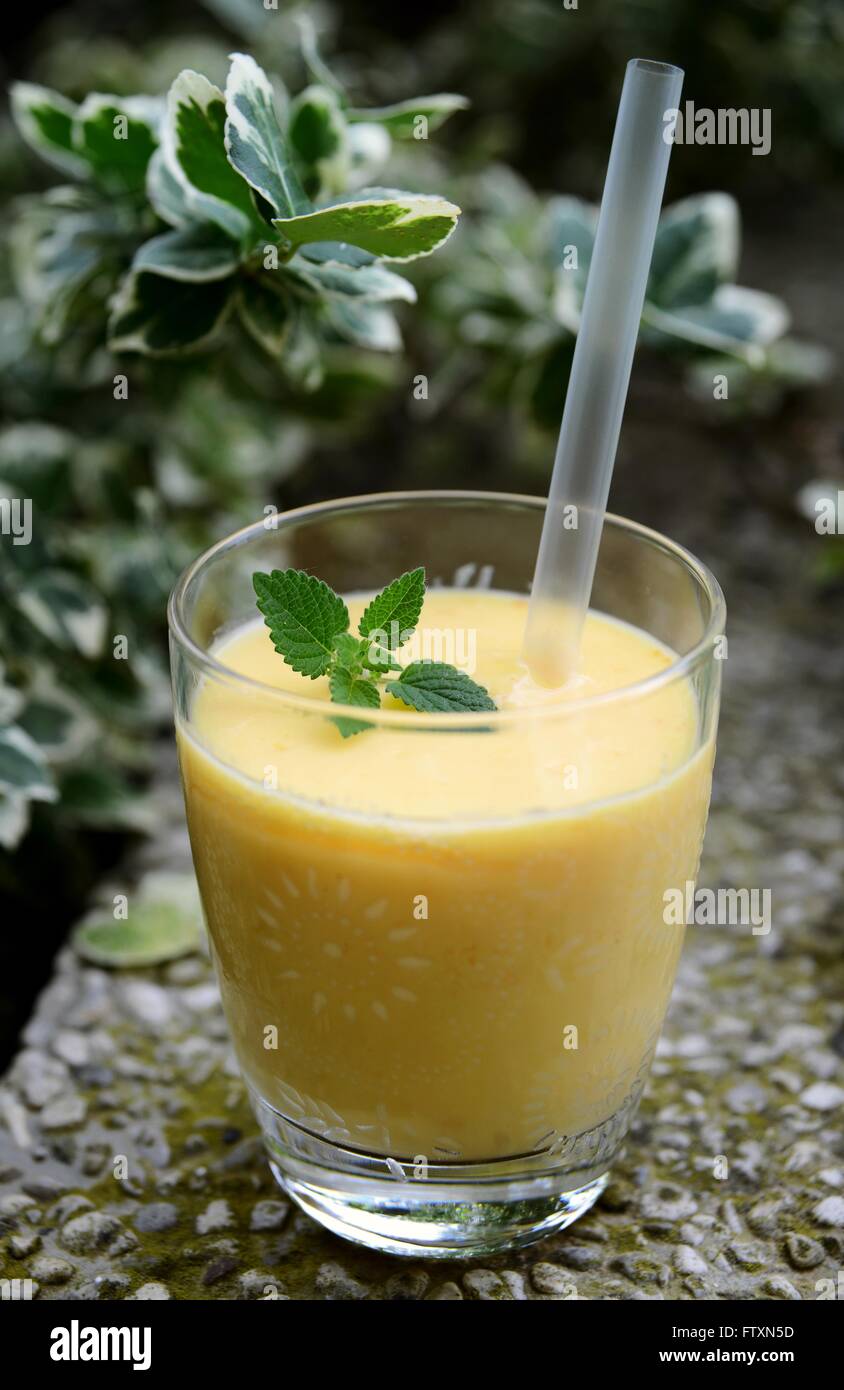 Glass of Mango lassi on a wall Stock Photo - Alamy