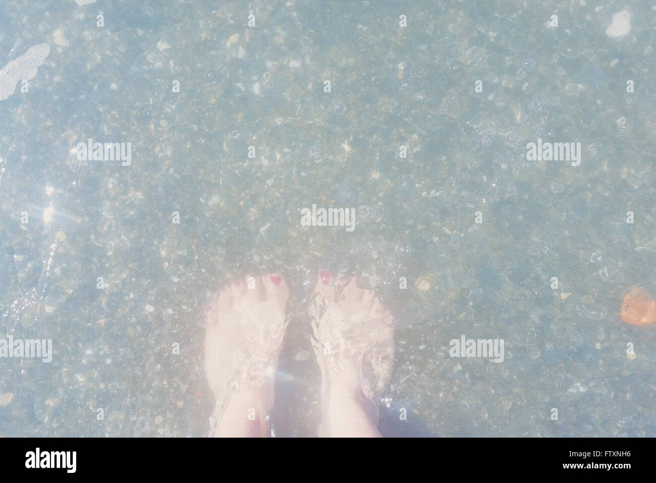 Woman's feet standing in sea Stock Photo - Alamy