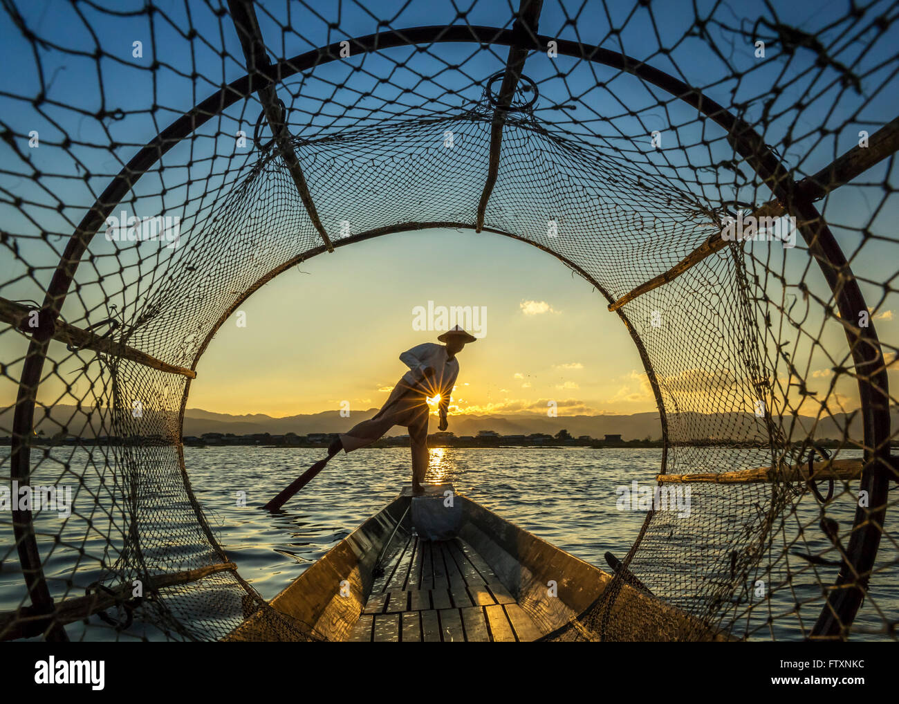 Fisherman Rowing fishing Boat, Inle Lake, Myanmar Stock Photo - Alamy