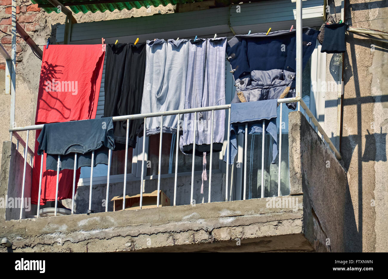 Drying freshly washed laundry on a clothesline outside the window Stock ...