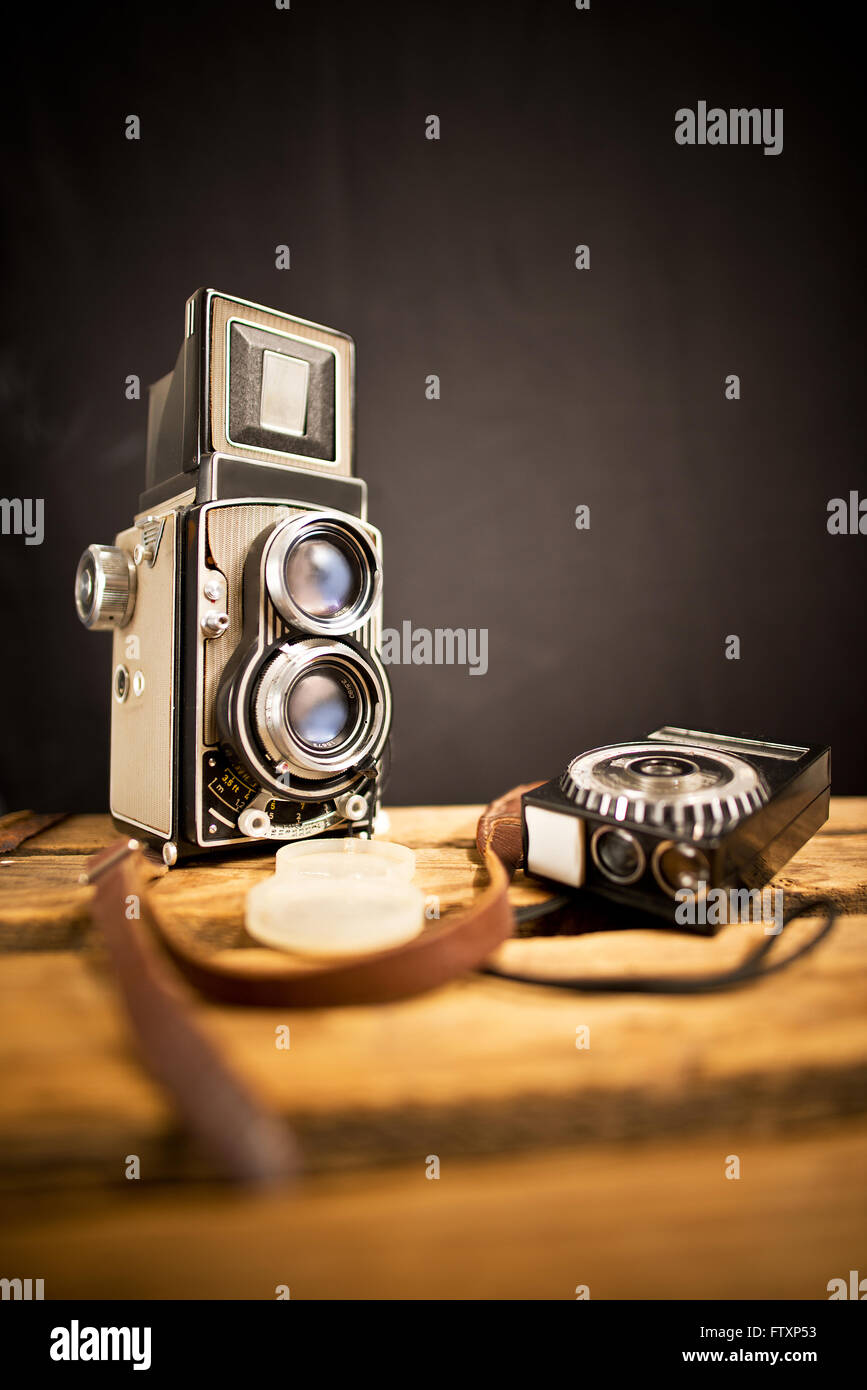 old twin-lens reflex camera with light meter on the black background ...