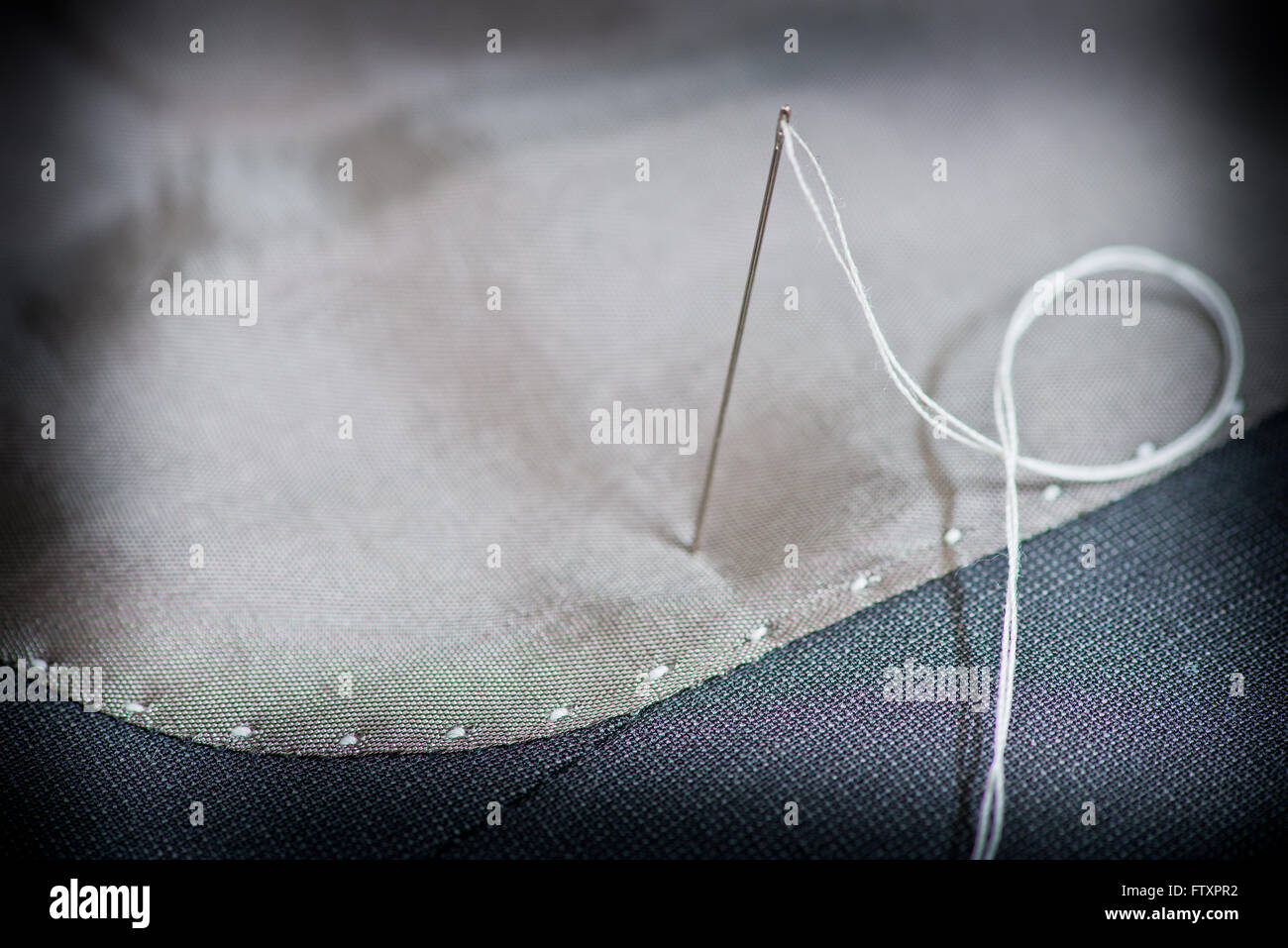 detail of a needle on the gray clothing Stock Photo - Alamy