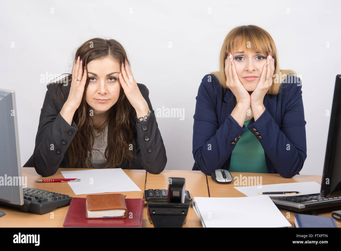 Two office employee sitting with depressed and frightened look Stock ...