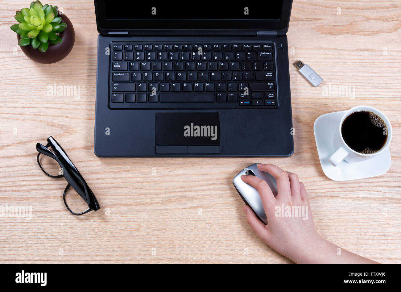 Overhead view of hand holding computer wireless mouse with laptop, baby ...