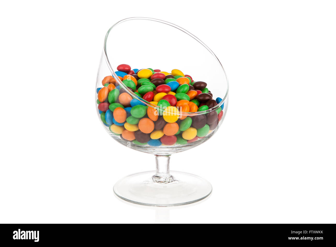 Colorful candy drops in glass isolated on white with reflection Stock ...