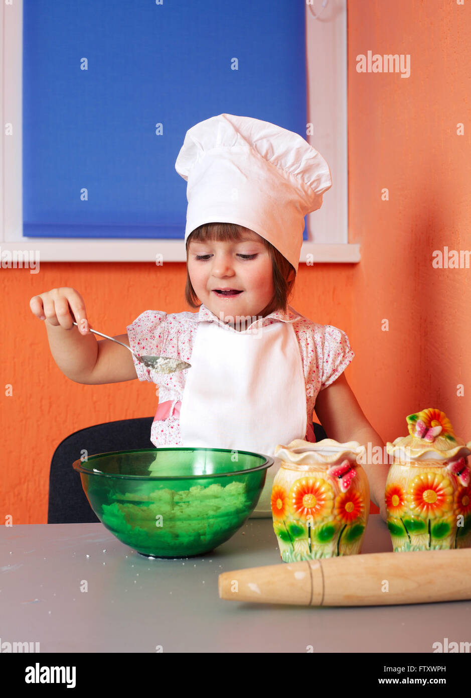 little cute chef cooking biscuits Stock Photo - Alamy