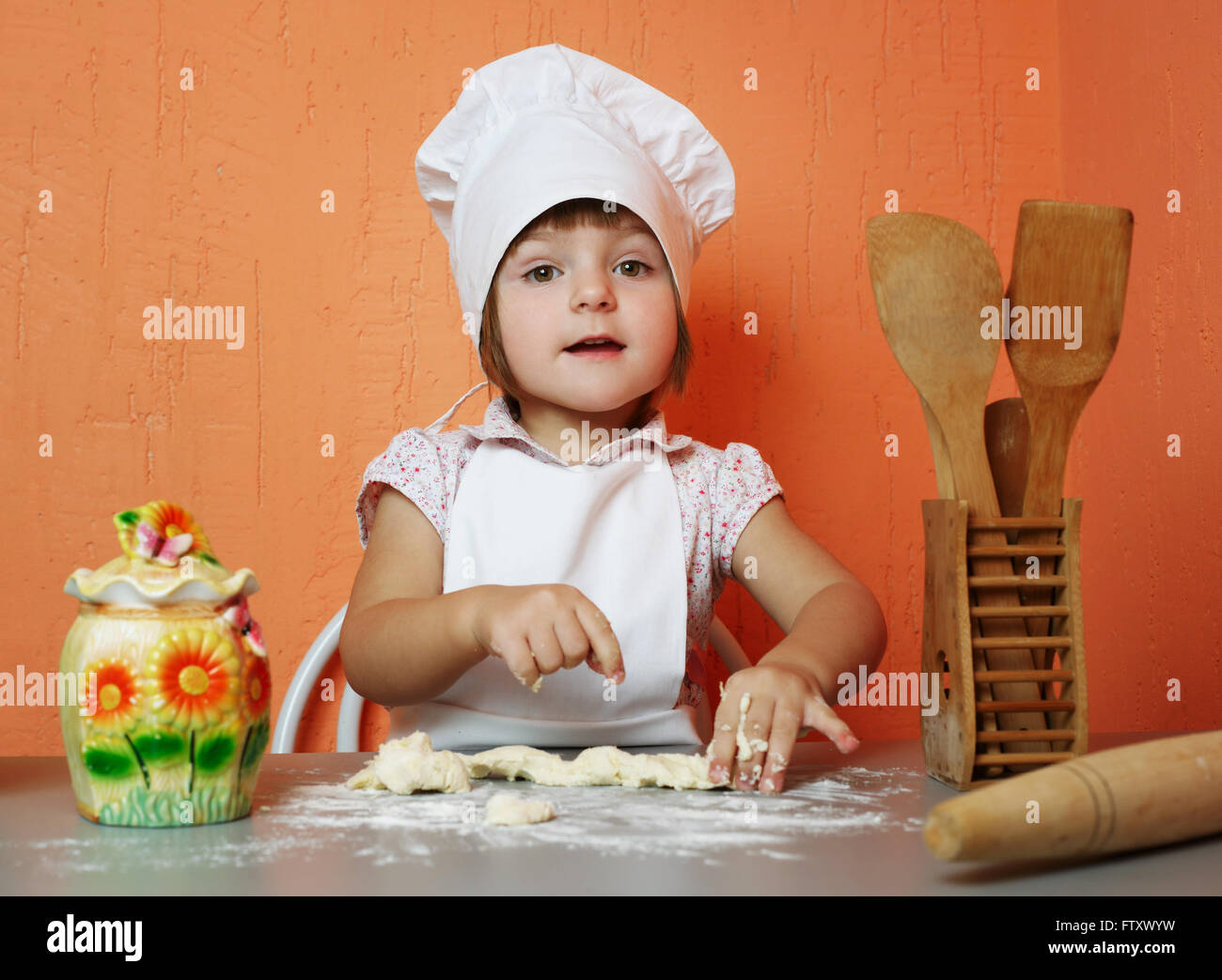 little cute chef cooking biscuits Stock Photo - Alamy