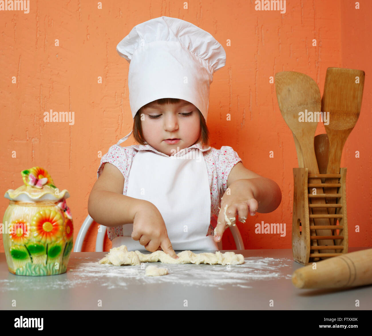 little cute chef cooking biscuits Stock Photo - Alamy