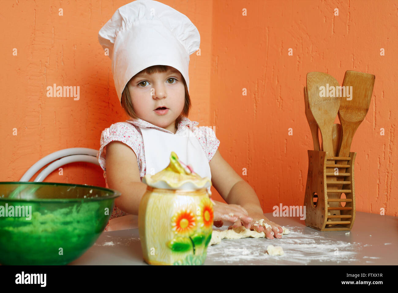 little cute chef cooking biscuits Stock Photo - Alamy