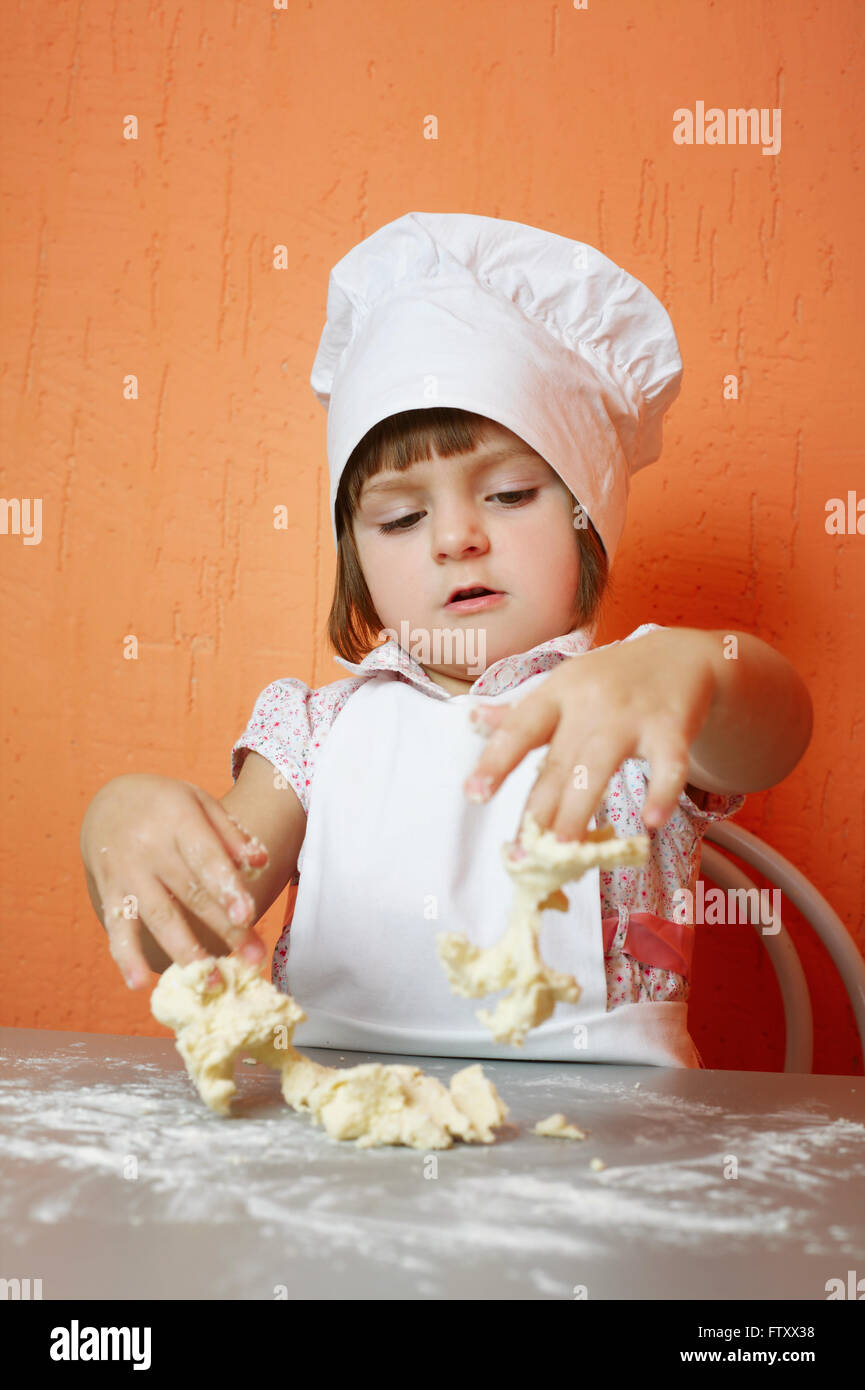 little cute chef cooking biscuits Stock Photo - Alamy