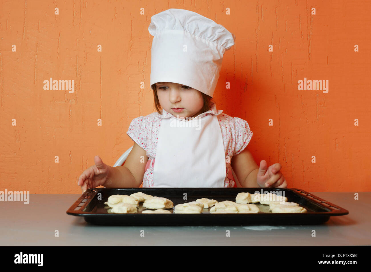 little cute chef cooking biscuits Stock Photo - Alamy