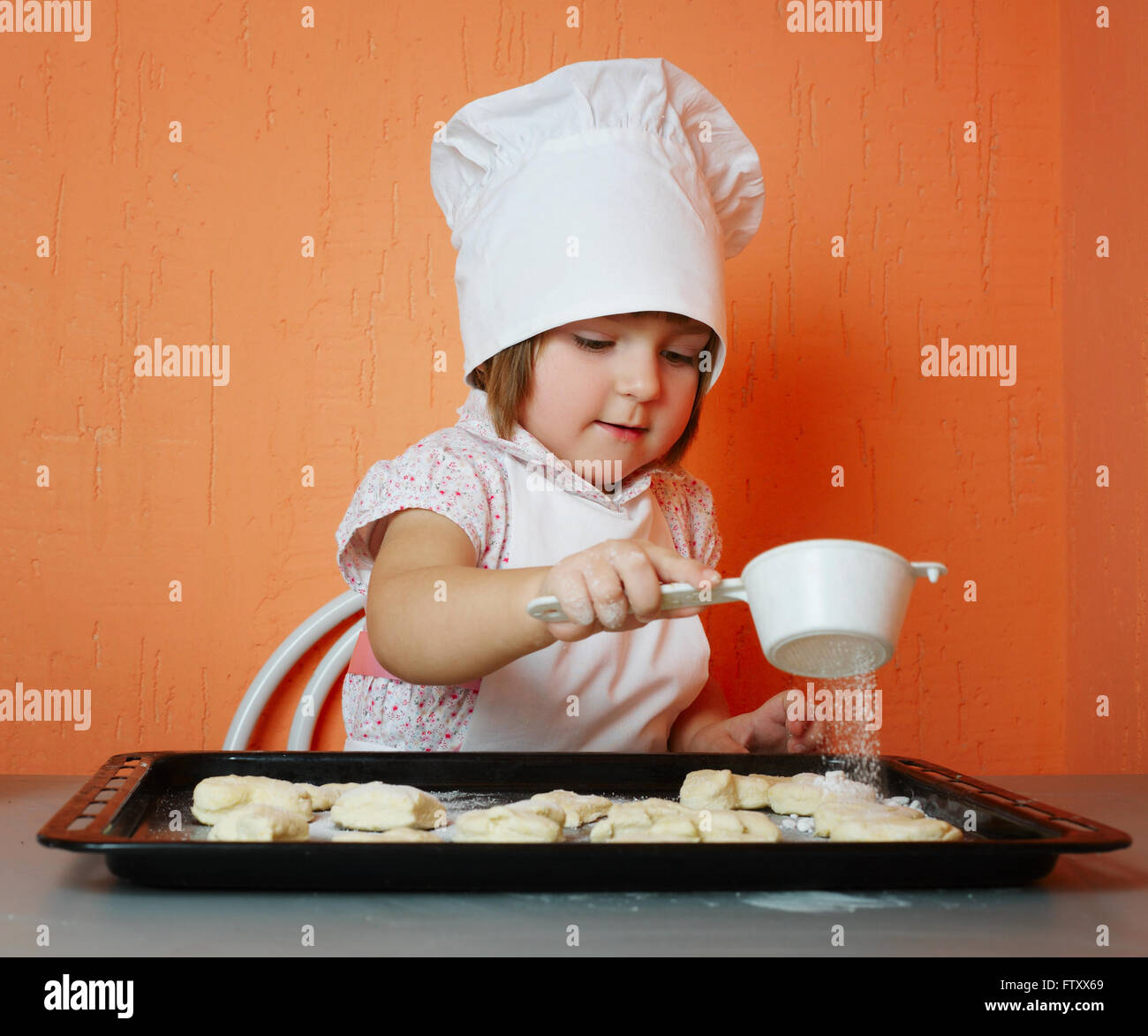 little cute chef cooking biscuits Stock Photo - Alamy