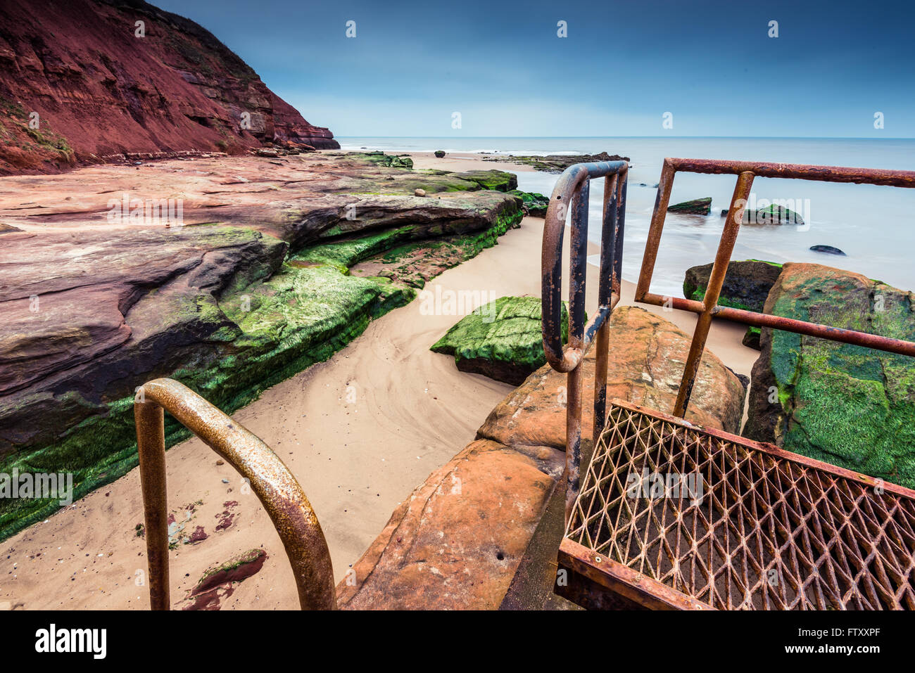 Wild beach and red rock cliffs in famous heritage site Jurassic Coast ...